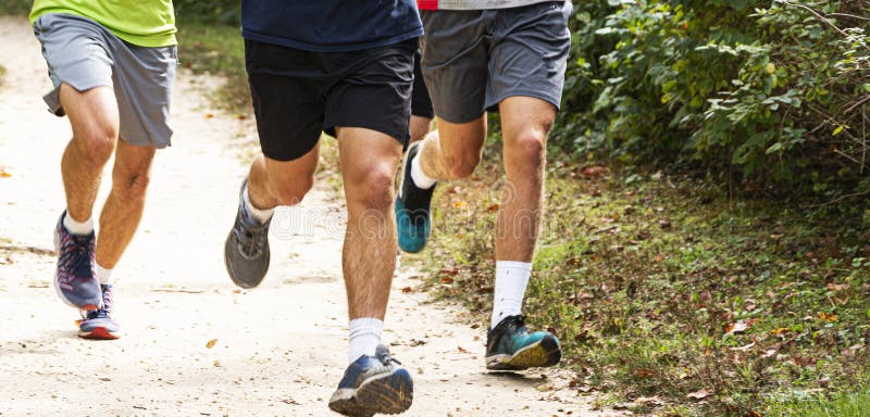 Legs of Three Runners Running on a Trail in a Park Stock Photo - Image ...