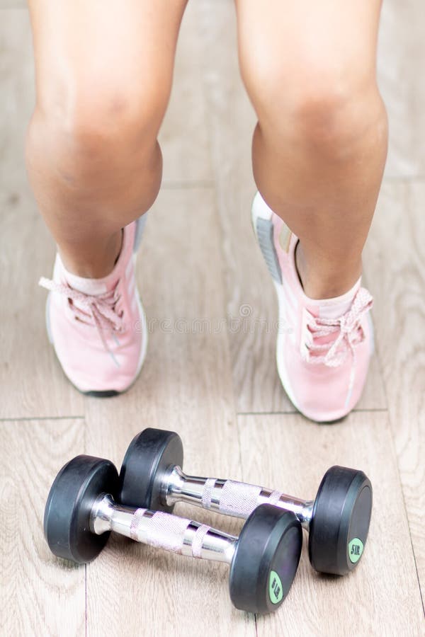 A Legs of a Training Woman with Steel Dumbbells Stock Image - Image of ...