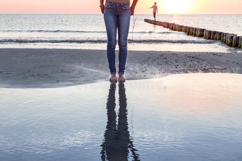 The Legs of a Woman Reflected in the Ocean Stock Image - Image of ...