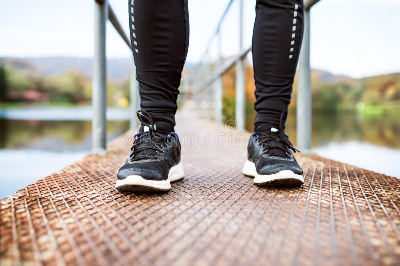 Legs of Young Runner Standing on a Pier. Stock Photo - Image of metal ...