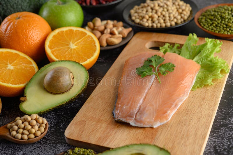 Legumes, Fruit, and Salmon Fish Pieces on a Wooden Chopping Board Stock ...