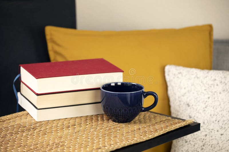 A Lot of Books with Cup of Coffee or Tea on the Table with Cozy Couch ...