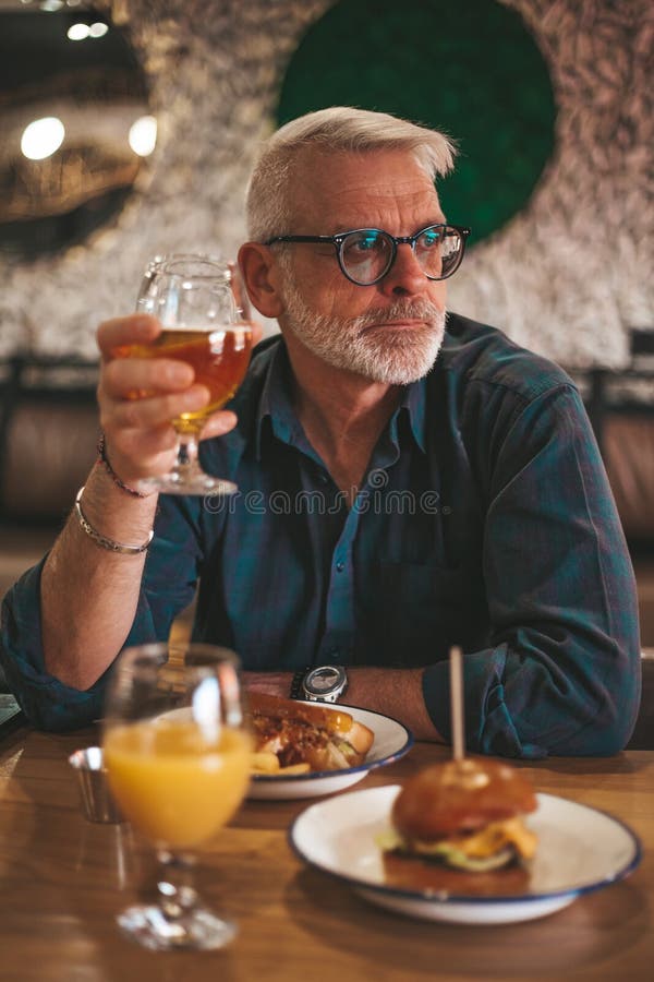 Leisure Time of a Mature Man in a Pub. the Client of the Bar Has Dinner ...