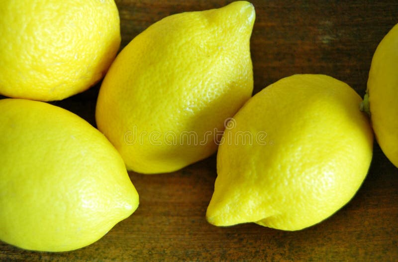 Five Lemons with Lemon Tree Leaves on Yellow Stock Photo - Image of ...