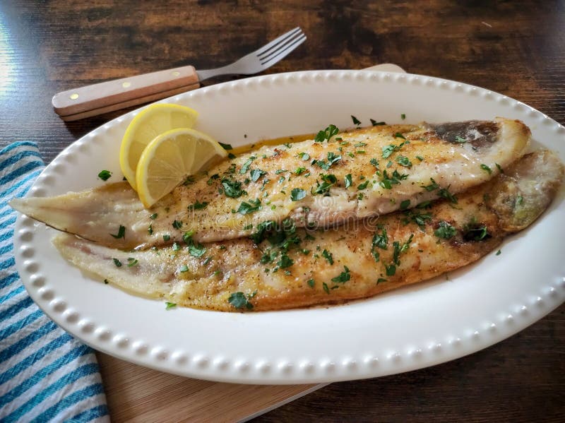 Lemon baked fish in a dish stock image. Image of cooked - 243605881