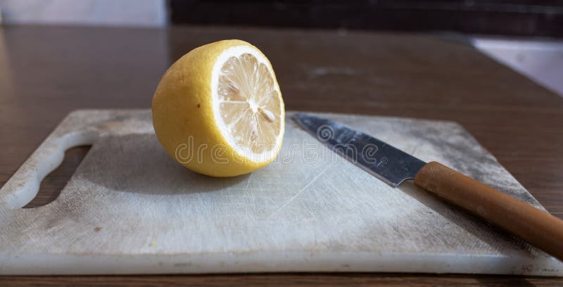 A Lemon Being Cut with a Knife Stock Photo - Image of yellow, indoors ...