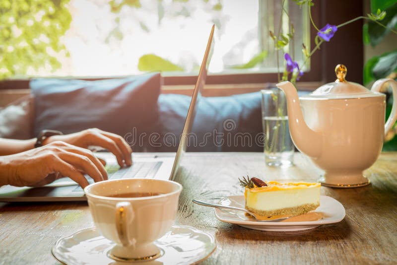 Lemon Cheesecake and Cup of Tea on Table with Businessman Working on ...