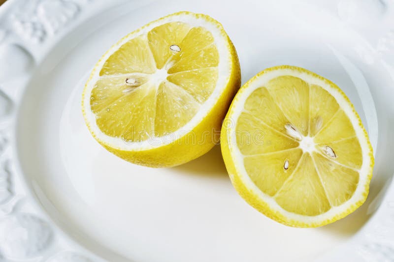 Lemon cut in half on plate stock image. Image of fresh - 270121417
