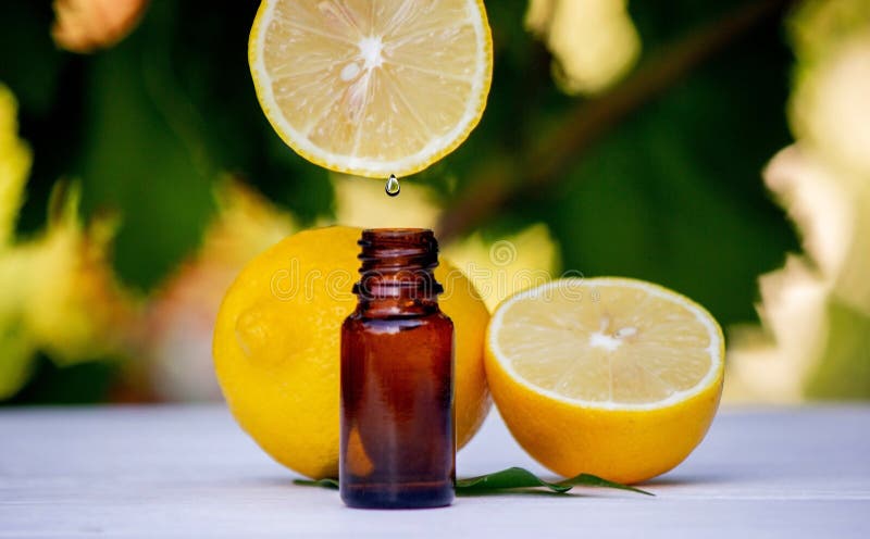 Lemon Essential Oil and Lemon Fruit on a Wooden White Board Stock Image ...