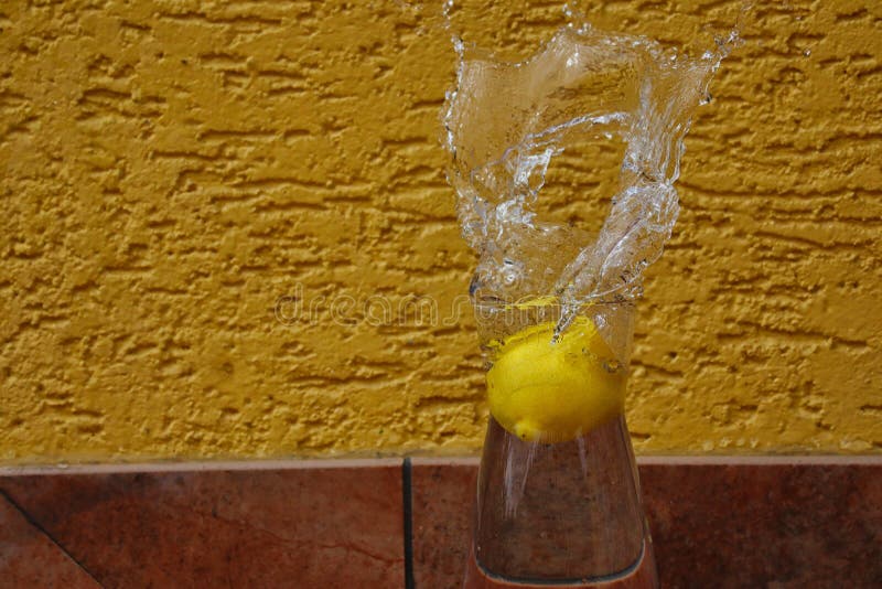 Lemon Falling into Glass Pitcher with Water Splash Stock Image - Image ...