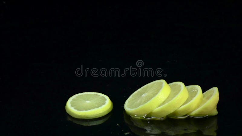 Lemon Dissolves into Slices when it Falls into the Water. Black ...