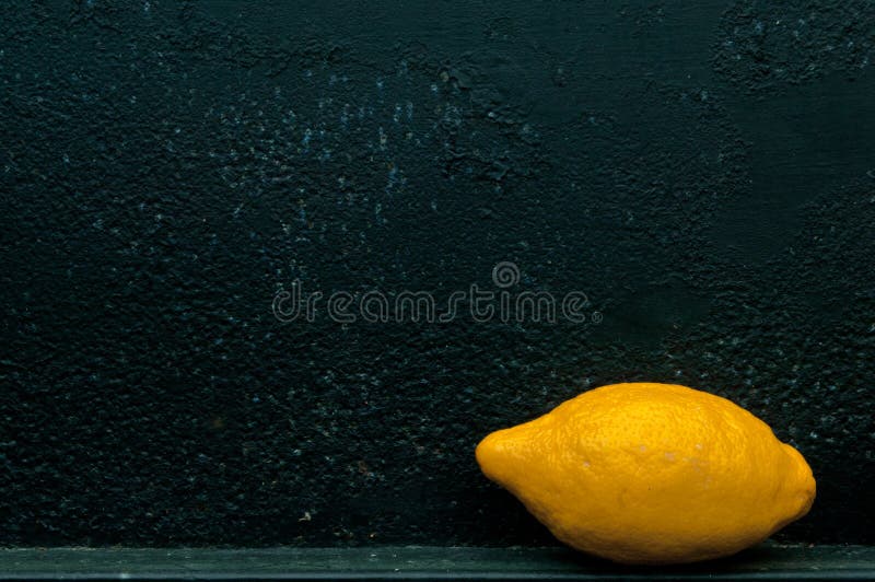 Lemon in Front of Rough Textured Black Background Stock Photo - Image ...