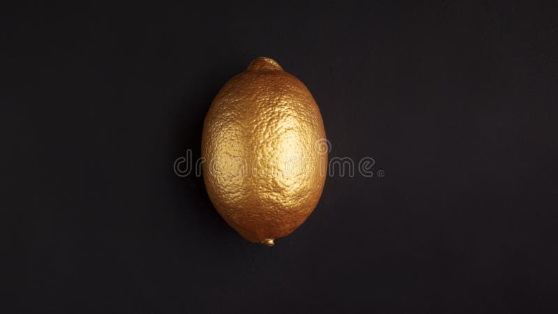 Lemon in Gold Paint Isolated on Black Background. Stock Image - Image ...