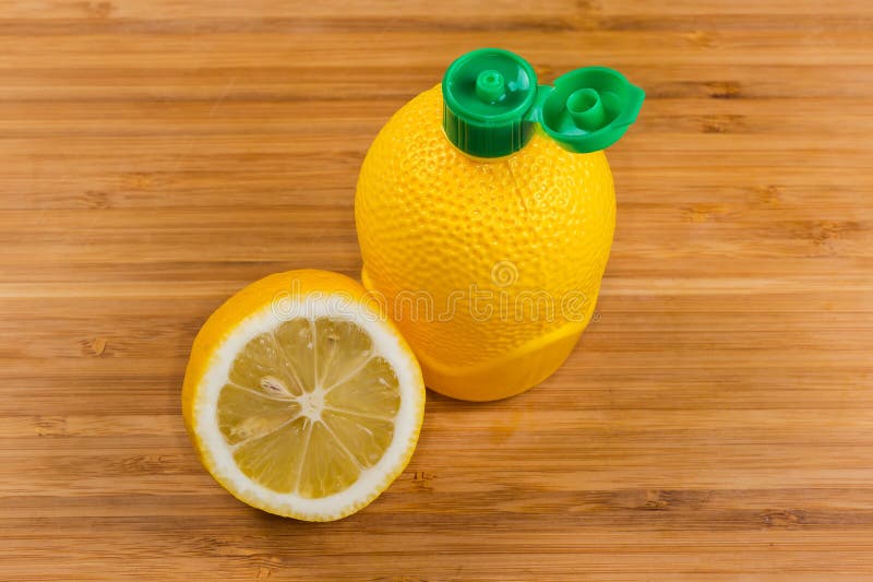 Lemon Juice in Plastic Container and Half of Fresh Lemon Stock Image ...
