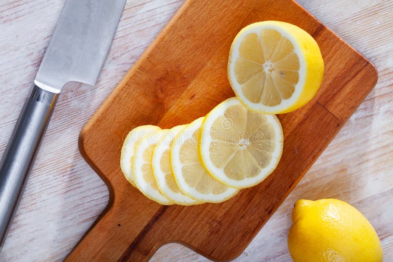 Lemon and Knife on Cutting Board Stock Image - Image of culinary, food ...