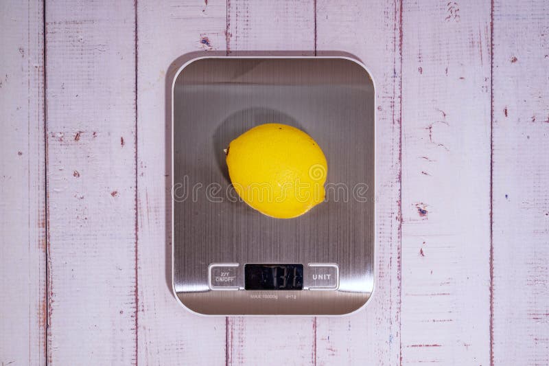 An Lemon Lies on a Digital Kitchen Scale on a Table of Light Boards ...