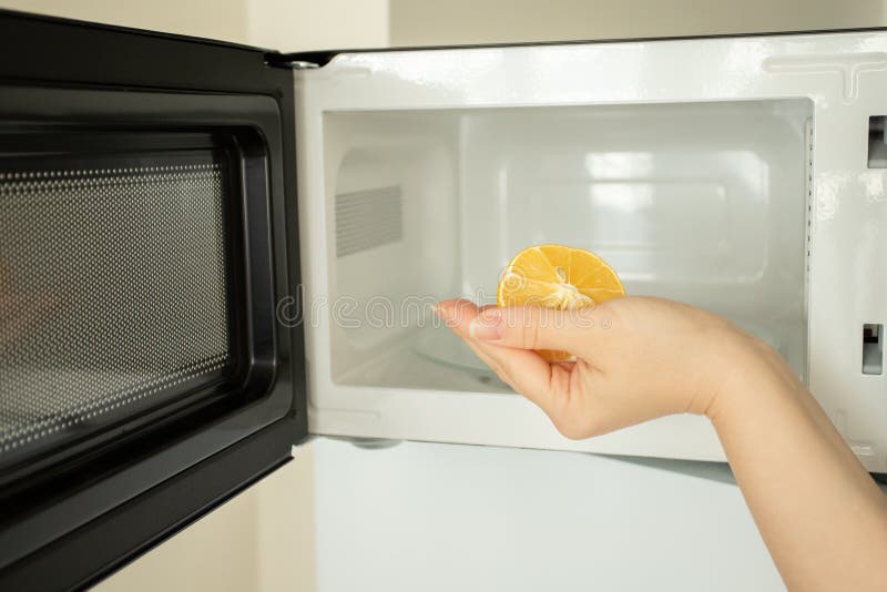 Lemon Microwave Cleaner in Female Hand Stock Photo - Image of dish ...