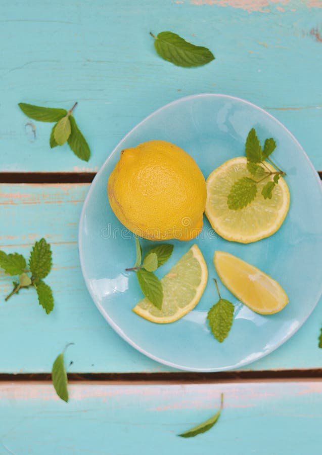 Lemon Slice with Mint Leaves on a Blue Green Background in the Shape of ...