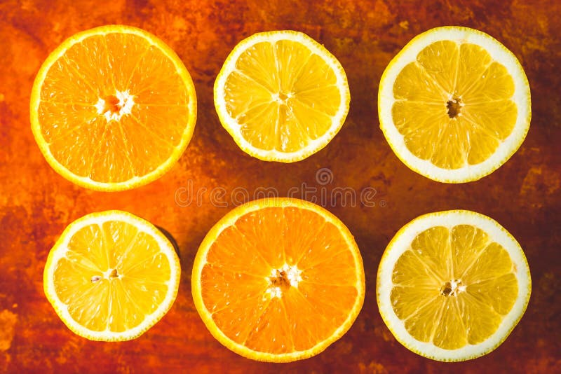 Lemon and Orange Slices on the Terracotta Background Top View Stock ...