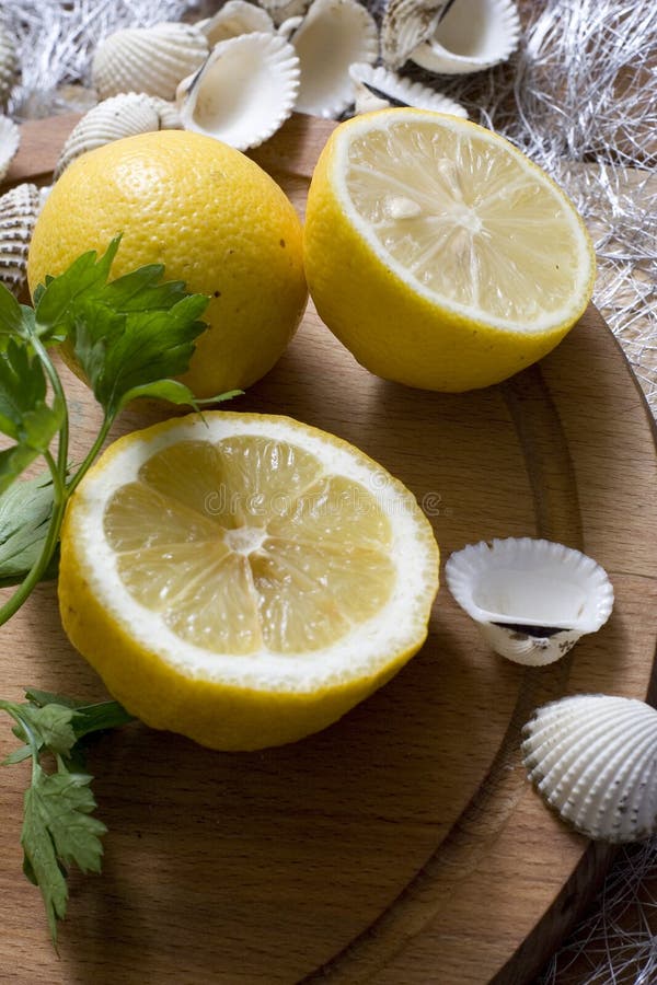 Lemon and seashells stock photo. Image of ocean, sand - 5605006