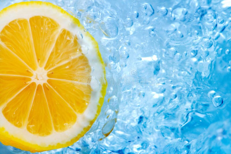 Lemon slice in blue water stock photo. Image of lemon - 17927256