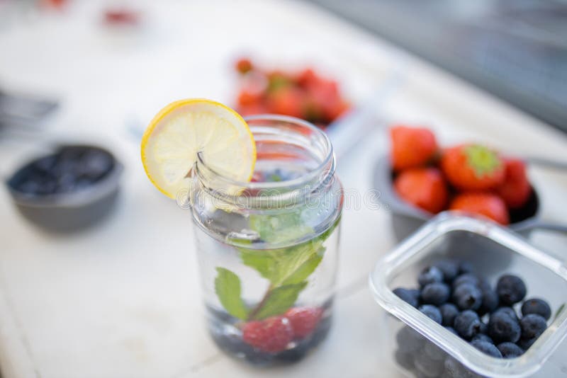 Lemon Slice on the Edge of a Glass with Berries Inside Stock Photo ...