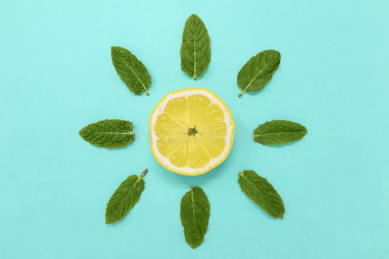 Lemon Slice with Mint Leaves on a Blue Green Background in the Shape of ...