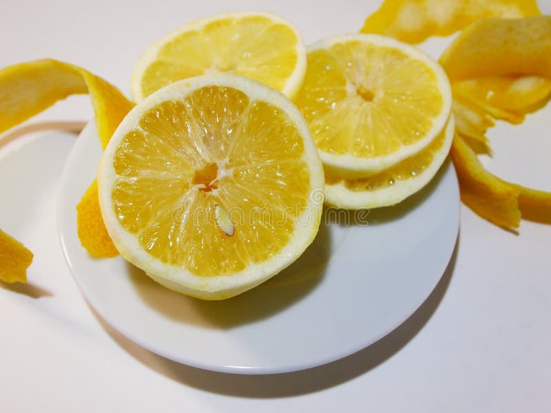 Lemon and Sliced Lemon Rind on a Plate on White Table Large Stock Image ...
