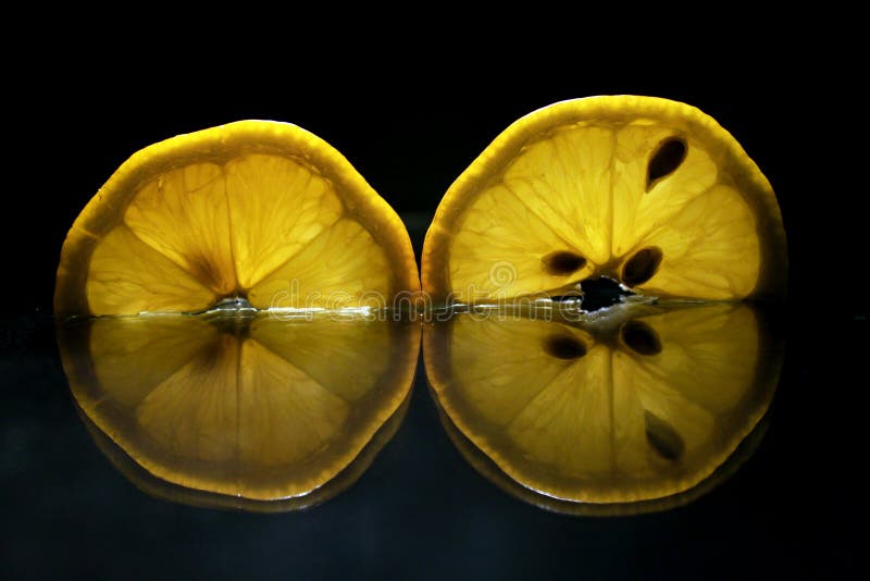 Two Yellow Fresh Lemon Cuts Slices Backlit Isolated on Black Background ...