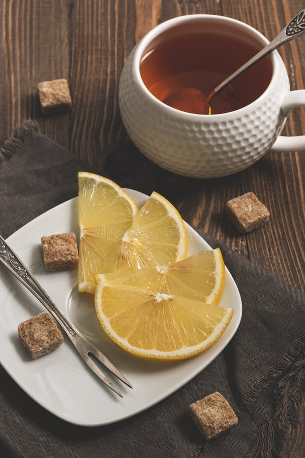 Lemon Slices, Lump Brown Sugar and a Cup of Tea on a Wooden Rustic ...