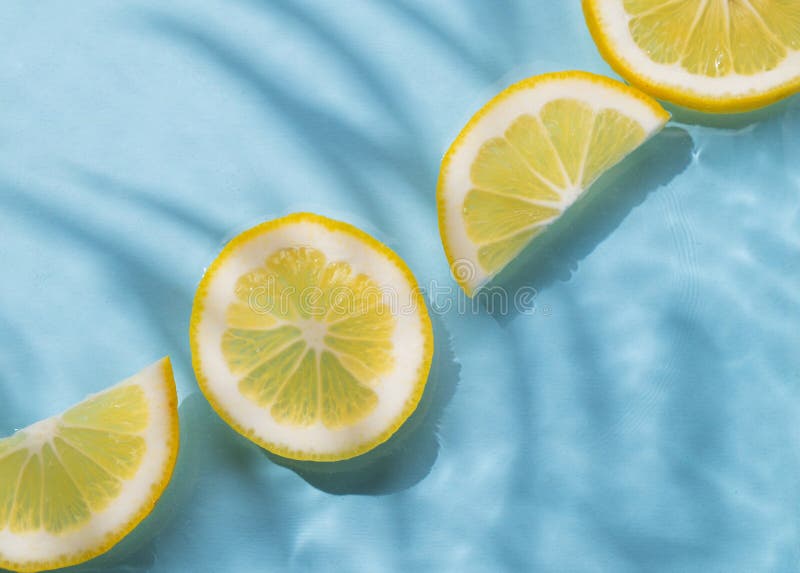 Lemon Slices in Water on a Blue Background with Shadow and Waves Close ...