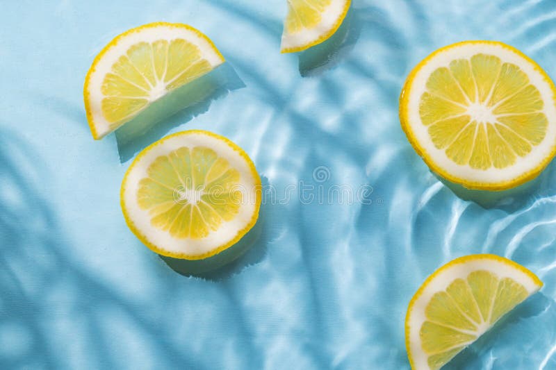 Lemon Slices in Water on a Blue Background with Shadow and Waves Close ...