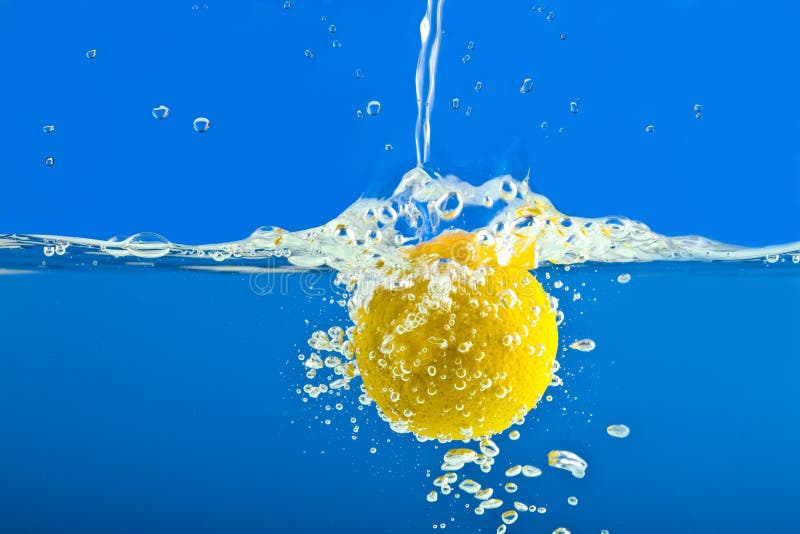 Lemon Splashing into Blue Water Stock Image - Image of fall, freshness ...