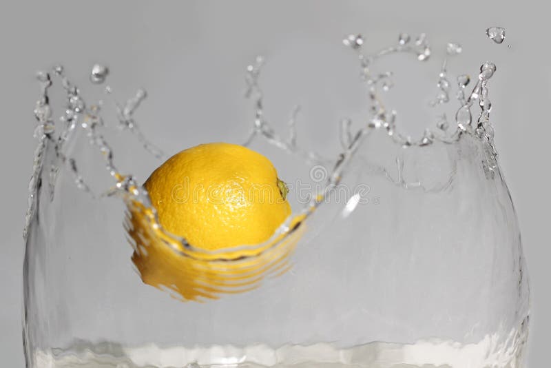 Lemon Splashing into Clear Water on White Background. Stock Photo ...