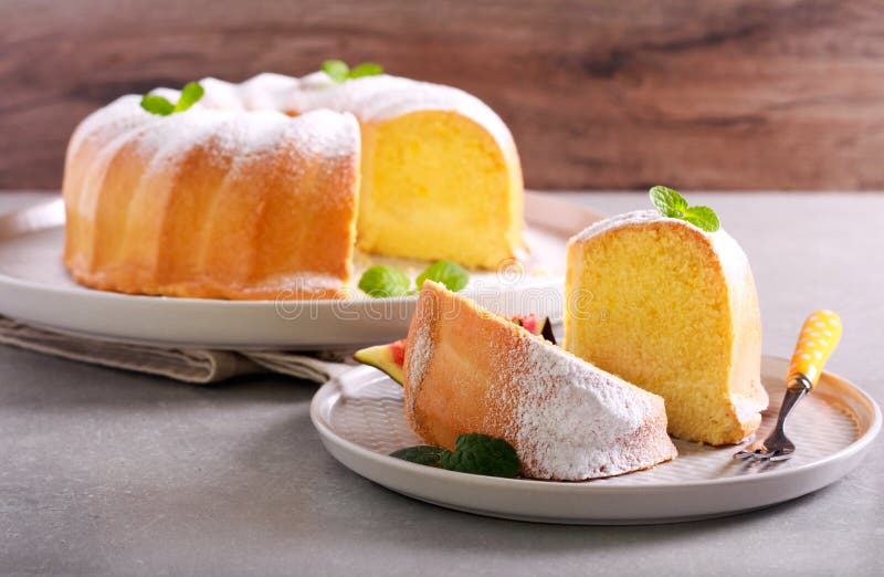Lemon Sponge Ring Cake with Icing Sugar Stock Photo - Image of slice ...