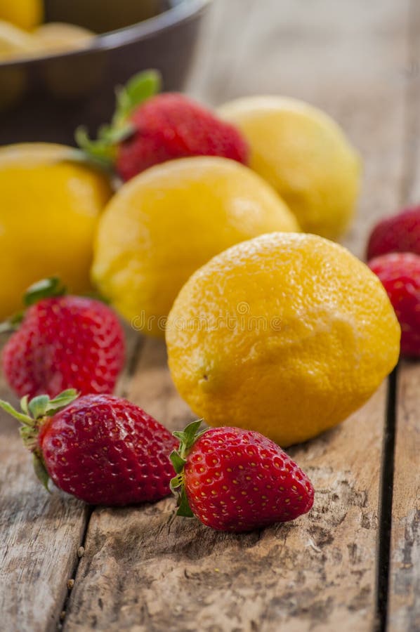 Lemon and strawberries stock photo. Image of rustic, cold - 69699992