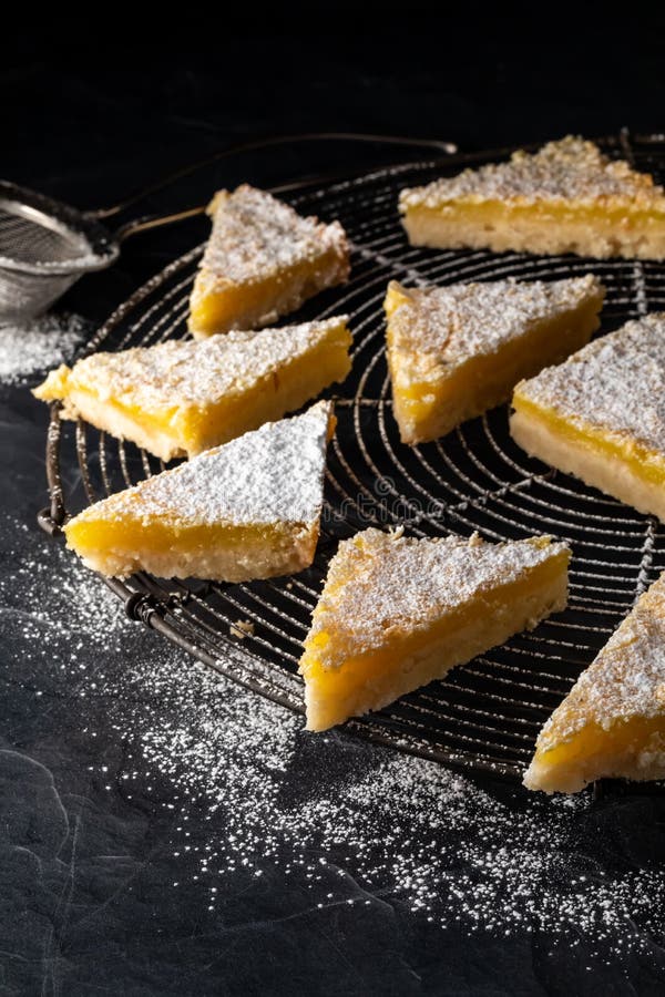 Lemon Triangles Covered in Powdered Sugar Against a Dark Background ...