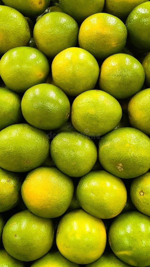 Lemon in Various Shades of Green on a Supermarket Stand with Different ...