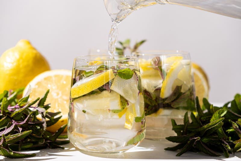 Lemon Water with Mint Pouring into Glass. Stock Image - Image of citrus ...