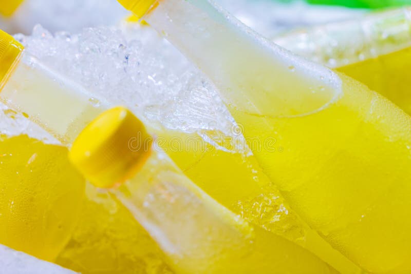 Lemonade bottles in ice stock image. Image of liquer - 76378895