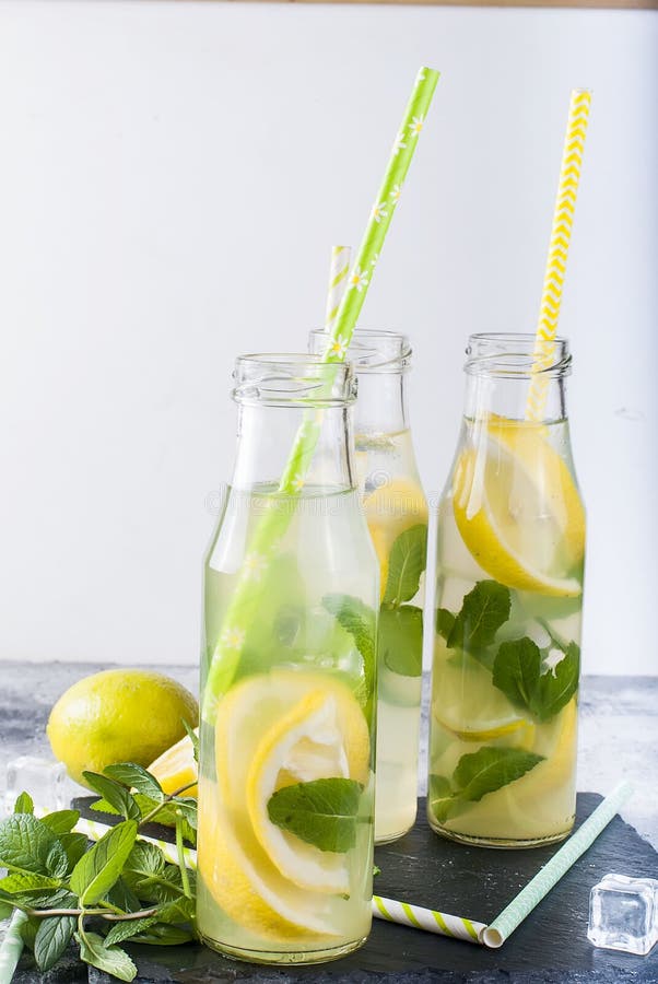 Lemonade in Bottles with Ice and Mint Stock Photo - Image of lime ...