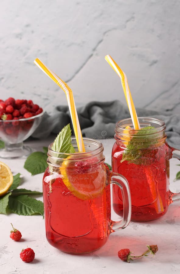 Lemonade or Cocktail with Raspberries, Mint, Lemon and Ice on a Grey ...