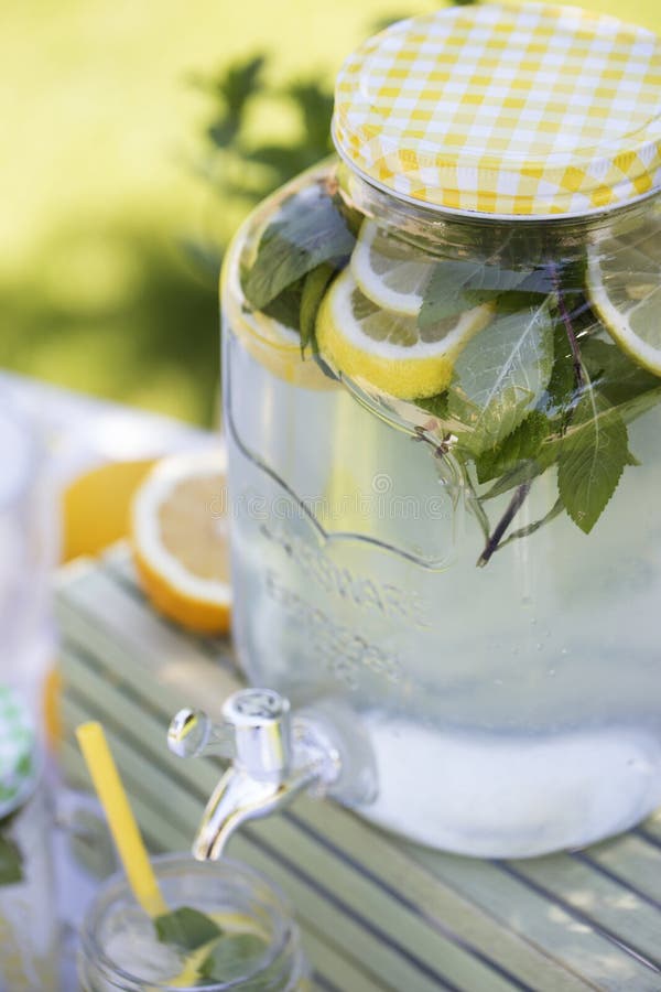 Lemonade in the Jug and Lemons with Mint on the Table Outdoor Stock ... Lemonade in the Jug and Lemons with Mint on the Table Outdoor Stock ...