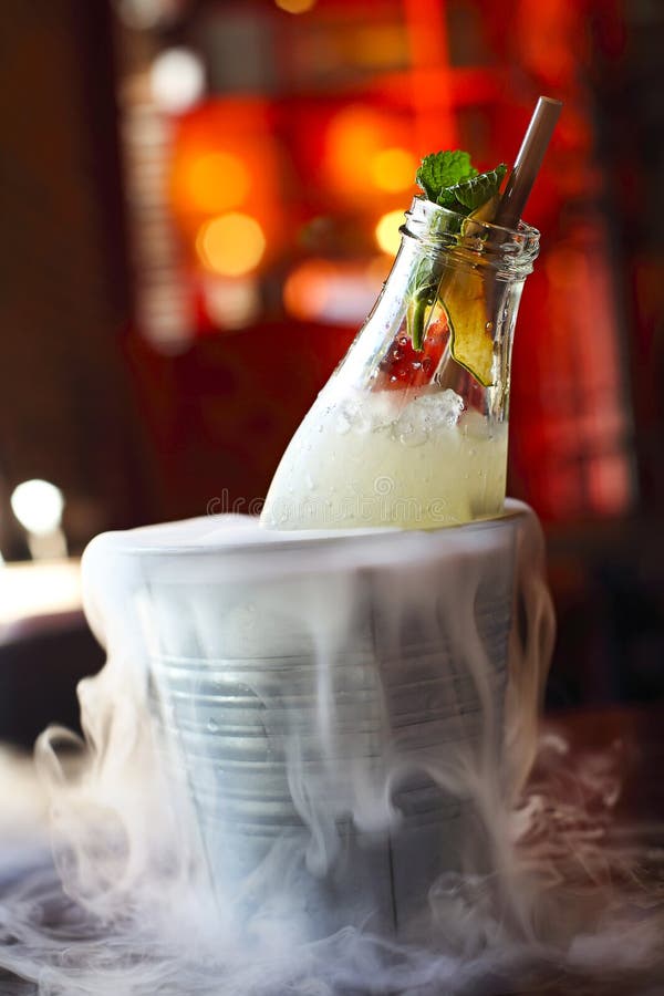 Lemonade Serviced in the Bottle with Mint in the Bucket with Dry Ice ...