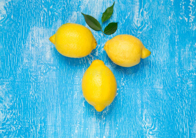 Lemons on blue background. stock image. Image of wooden - 153049011