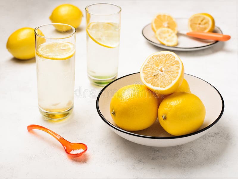 Lemons in a Bowl and Glasses of Lemon Juice Drinks Stock Photo - Image ...