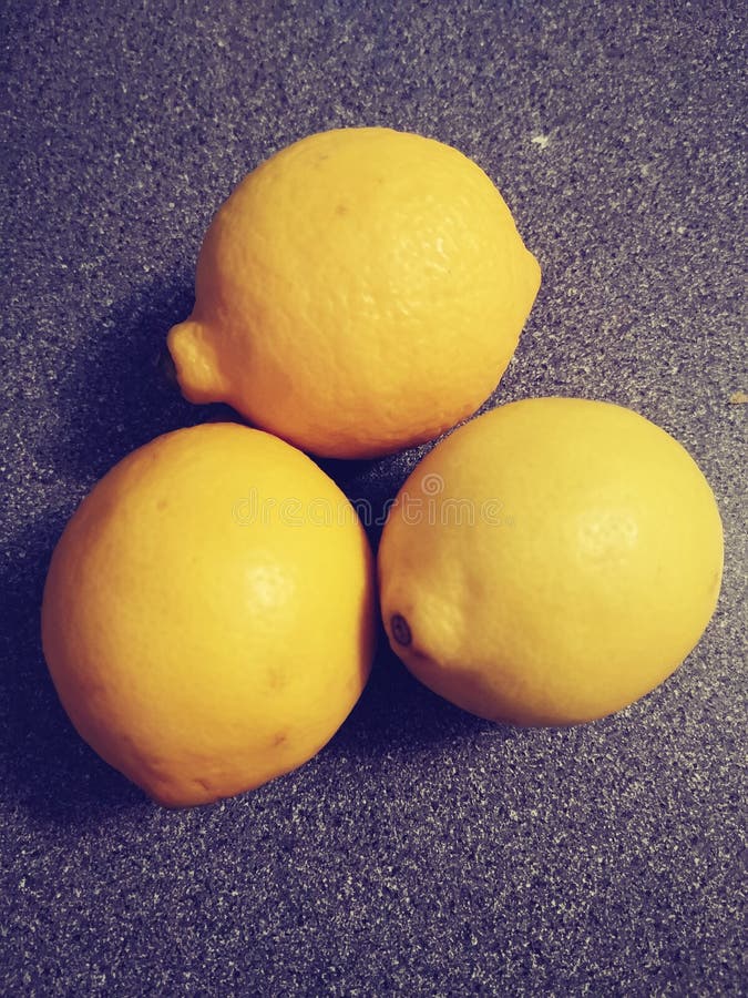 Three Yellow Lemons on the Table Stock Image - Image of table, lemons ...