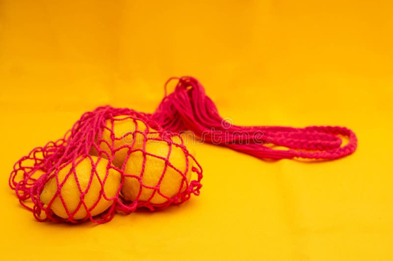 Lemons in Red Eco Shopping String Bag on Yellow Background. Eco ...