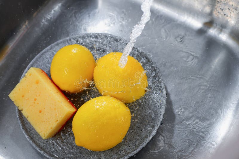 Lemons in a Sink Under Running Water Stock Photo - Image of food ...