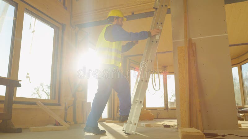 LOW ANGLE: Builder Climbs Up a Stepladder Placed Inside Prefabricated ...